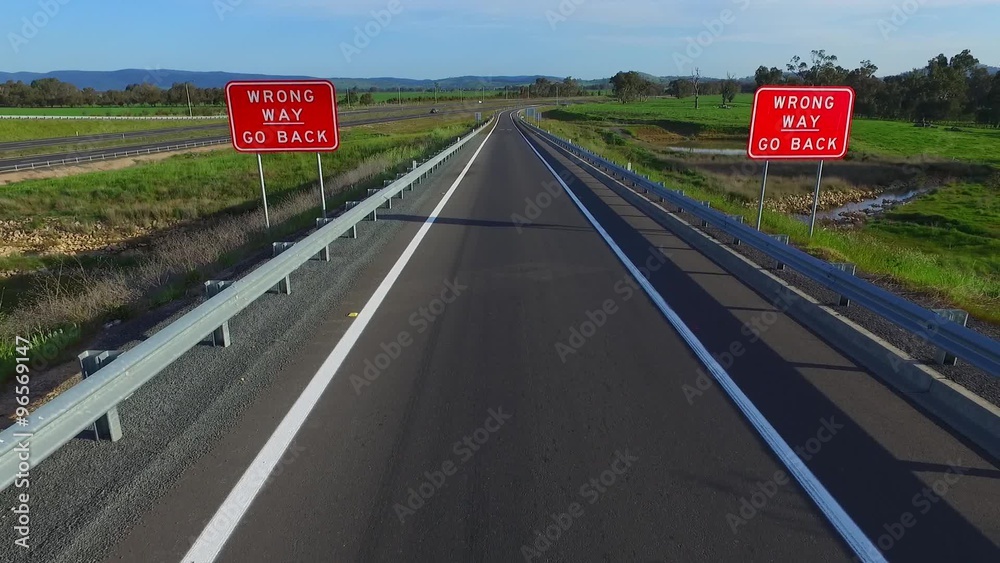Wrong way go back road signage on major high speed highway (freeway ...