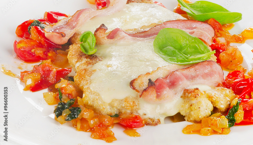 Chicken breast fillet baked with cheese, bacon and tomatoes. Stock ...