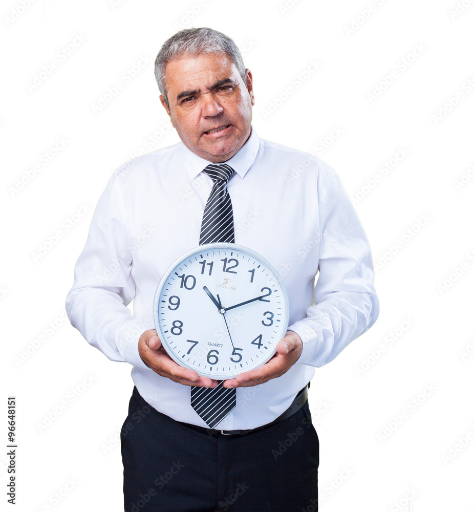 worried mature man holding a clock Stock Photo | Adobe Stock