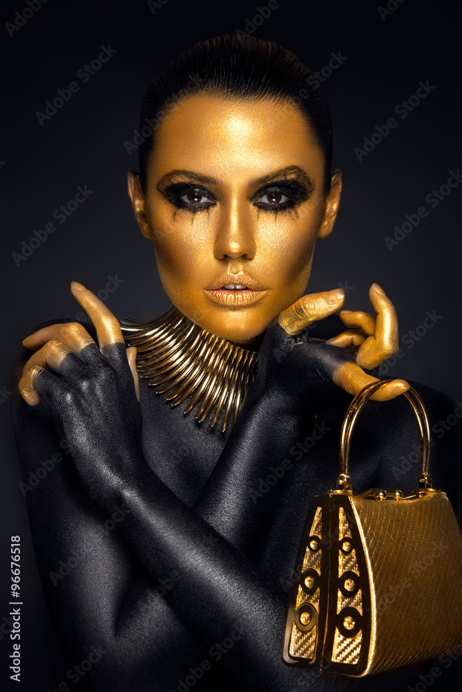 Beautiful woman portrait in gold and black colors Stock Photo | Adobe Stock
