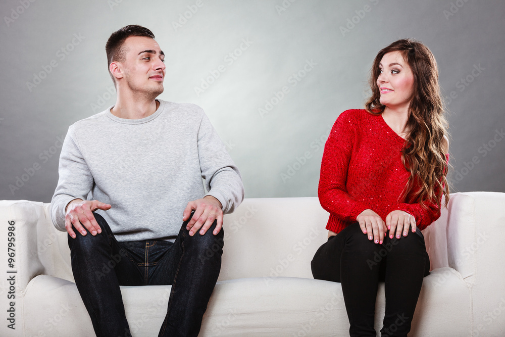 Shy woman and man sitting on sofa. First date. Stock Photo | Adobe Stock