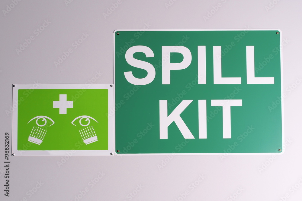 Emergency spill kit wall signs in green on off white background on a ...