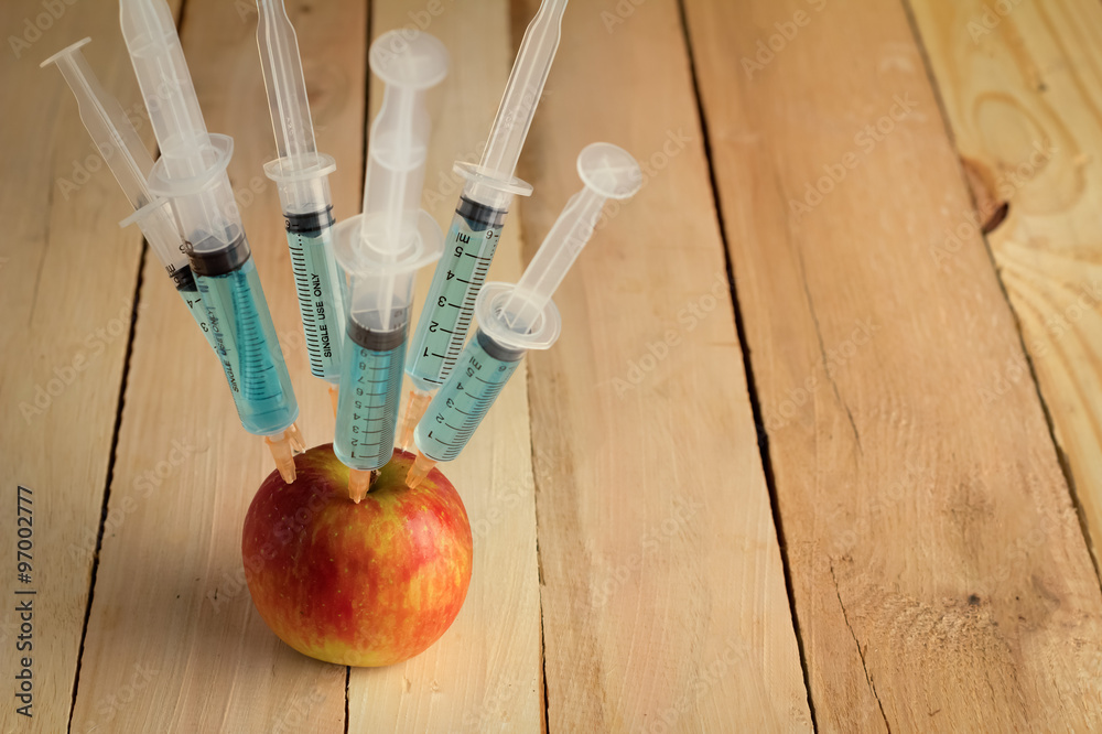 Injection into red apple Stock Photo | Adobe Stock