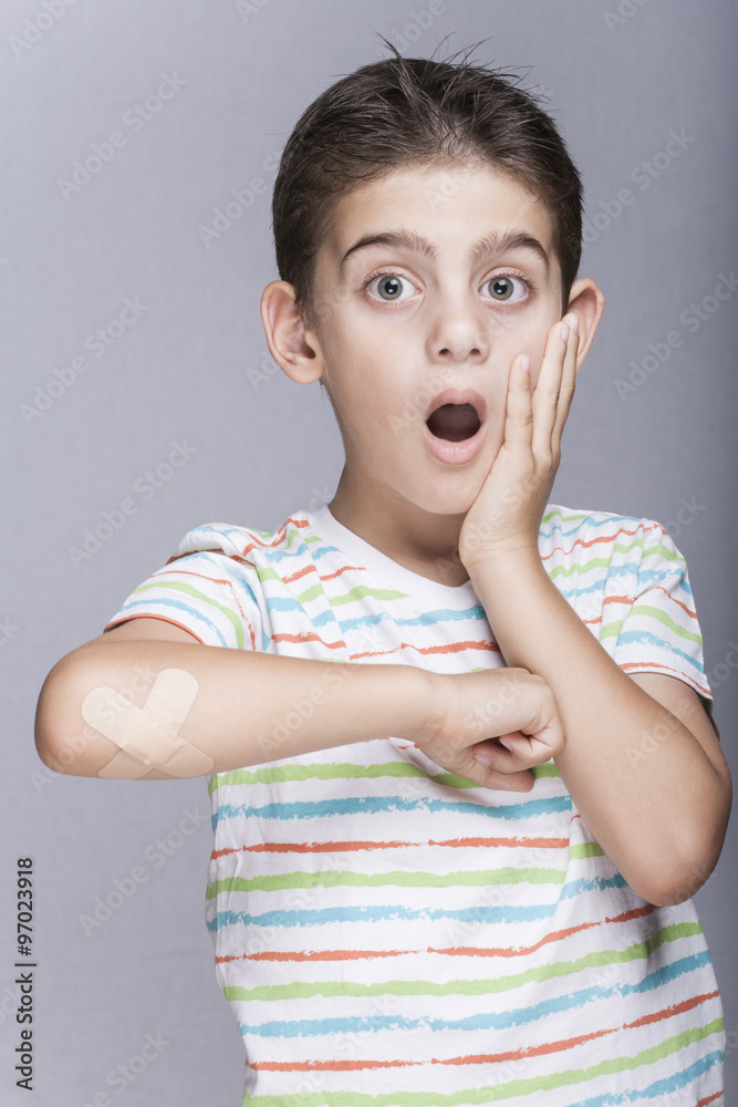 Injured boy with a a bruised elbow reacts in pain Stock Photo | Adobe Stock