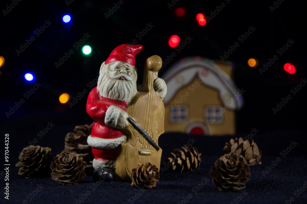 Decorative Santa Claus playing cello. Christmas music. Stock Photo ...