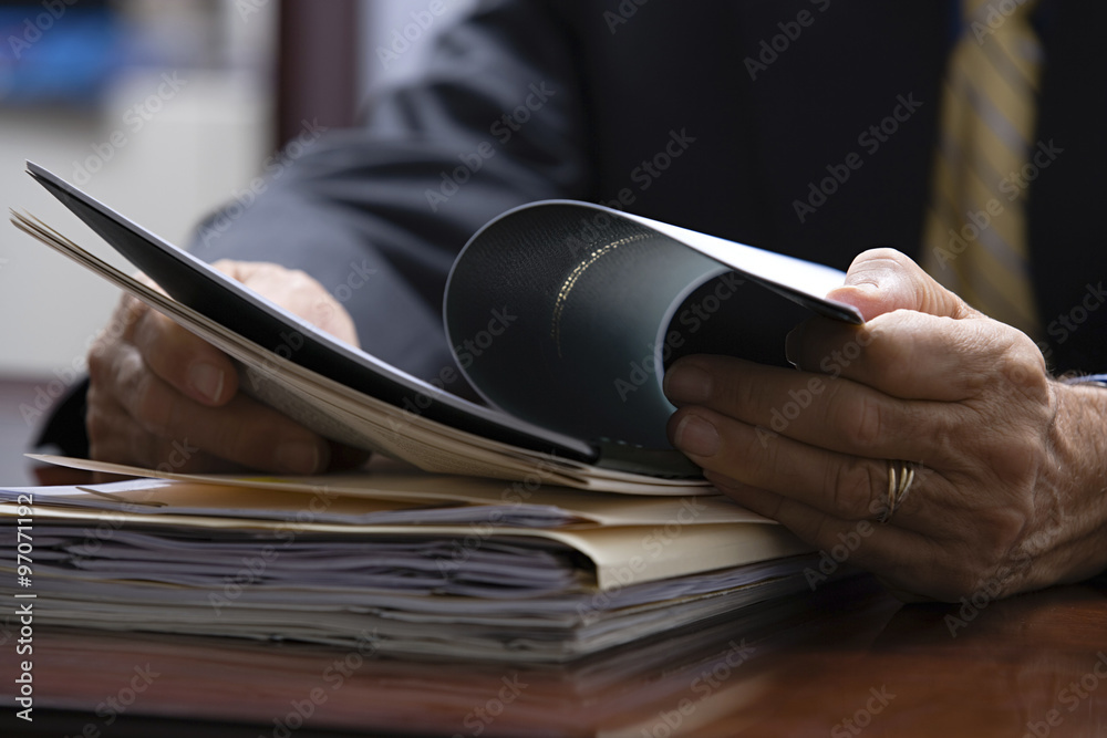 Businessman looking at paperwork Stock Photo | Adobe Stock