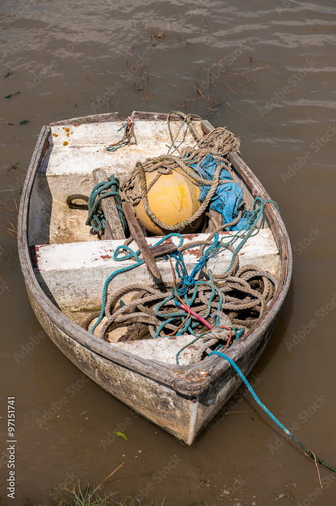 Single floating boat on water with ropes and equipment onboard Stock ...
