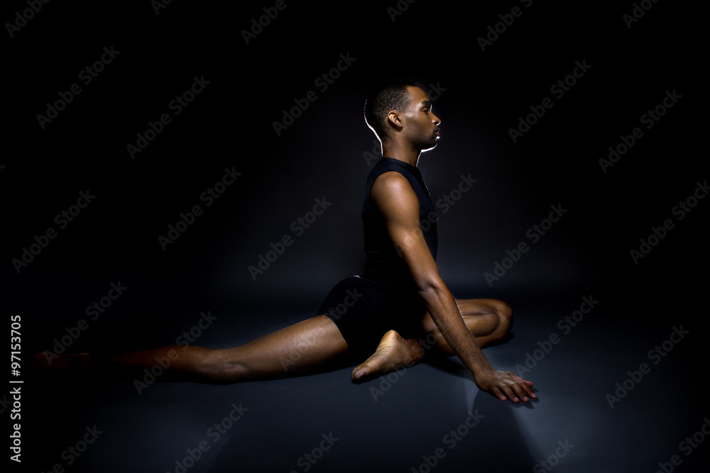 Black male dancer practicing warm up exercises for flexibility Stock ...