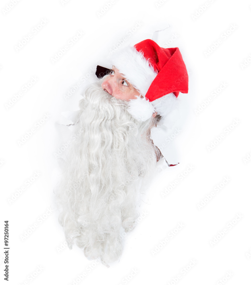 Santa Claus looking through hole in a white wall Stock Photo | Adobe Stock
