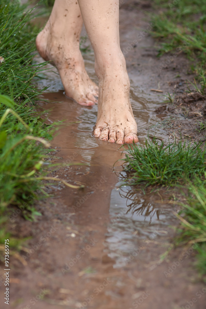 feet of woman in puddles after rain Stock Photo | Adobe Stock