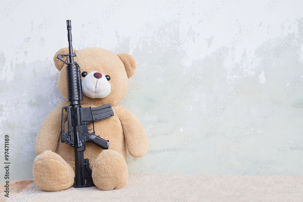 Teddy bear with toy gun Stock Photo | Adobe Stock