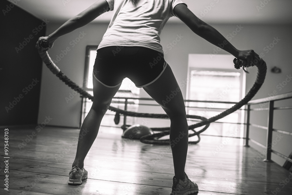 A determined female gym-goer works up a sweat while energetically using ...