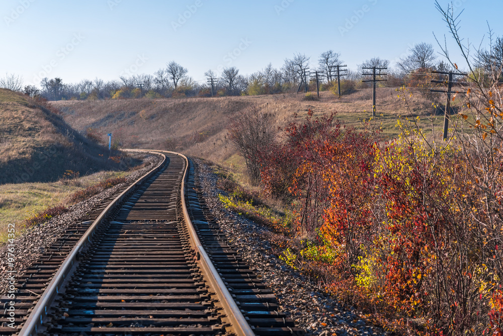 Rusty railroad tracks. Rusty railroad tracks turning to the left under ...