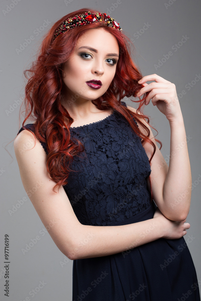Beautiful red-haired fashion model posing in evening dress and in the ...