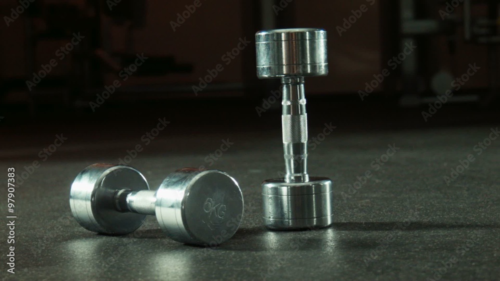 Vidéo Stock two dumbbells in gym | Adobe Stock
