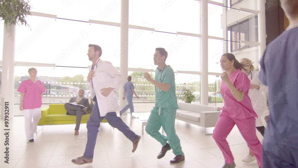 Medical team running through hospital building, responding to an ...