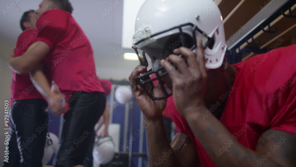 Portrait of American football player in locker room after the game ...