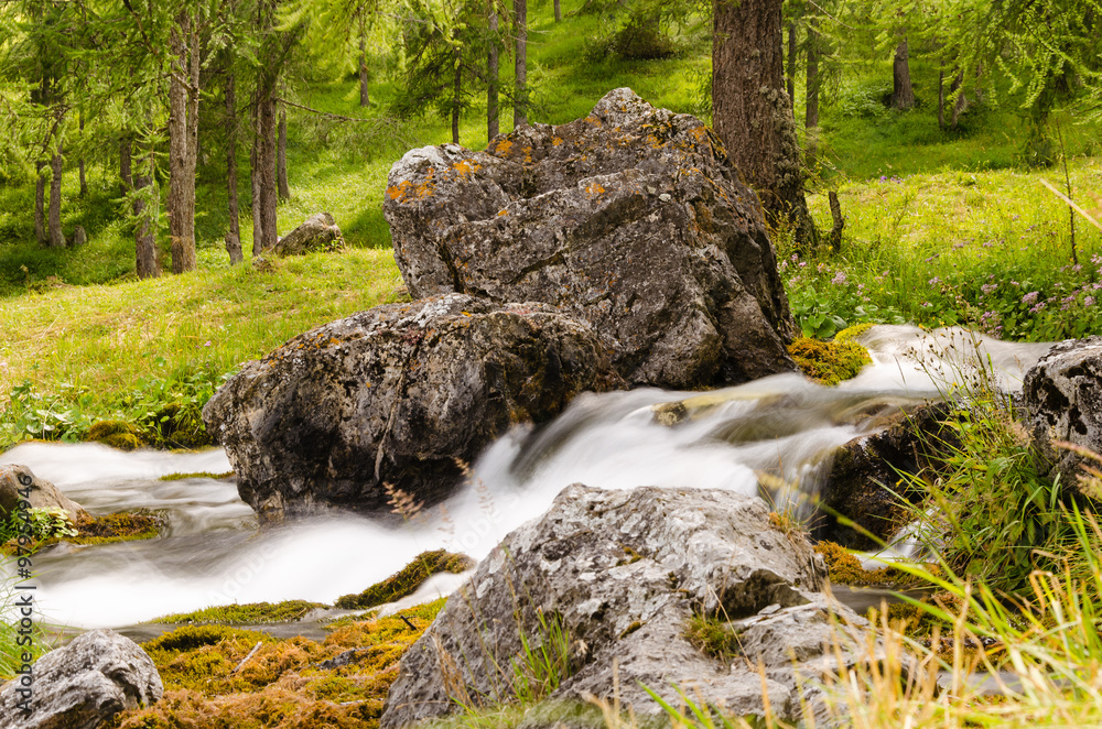 sights of a big rocks in the middle of a furios stream of water. symbol ...