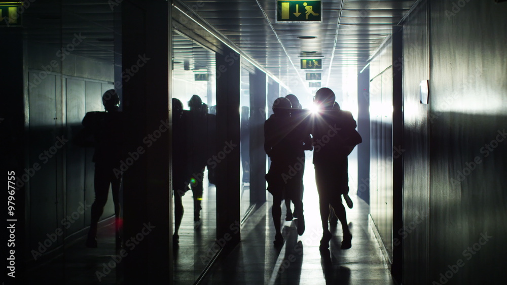 Excited American football team celebrate a victory as they run through ...