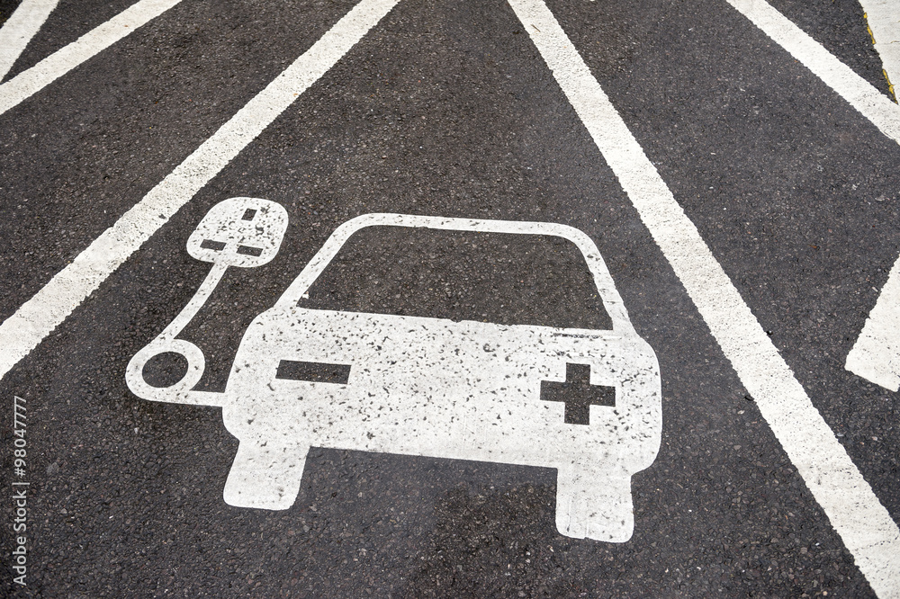 Electric vehicle charging station sign in a parking bay painted on ...