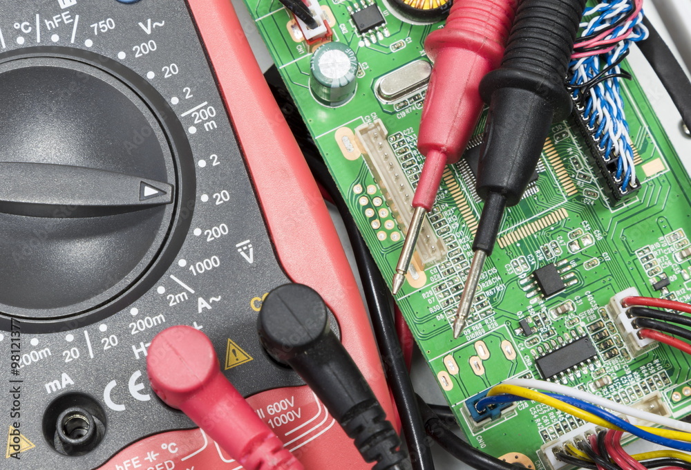 Red multimeter on motherboard background Stock-Foto | Adobe Stock