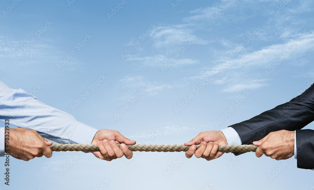 Tug war, two businessman pulling rope in opposite directions Stock ...