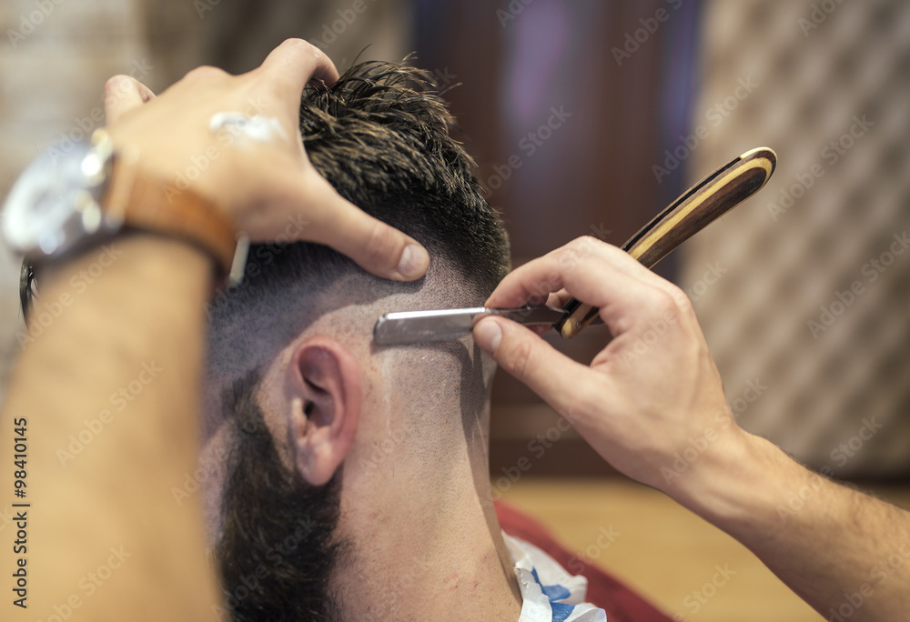 Barber shaving head of a customer Stock-Foto | Adobe Stock