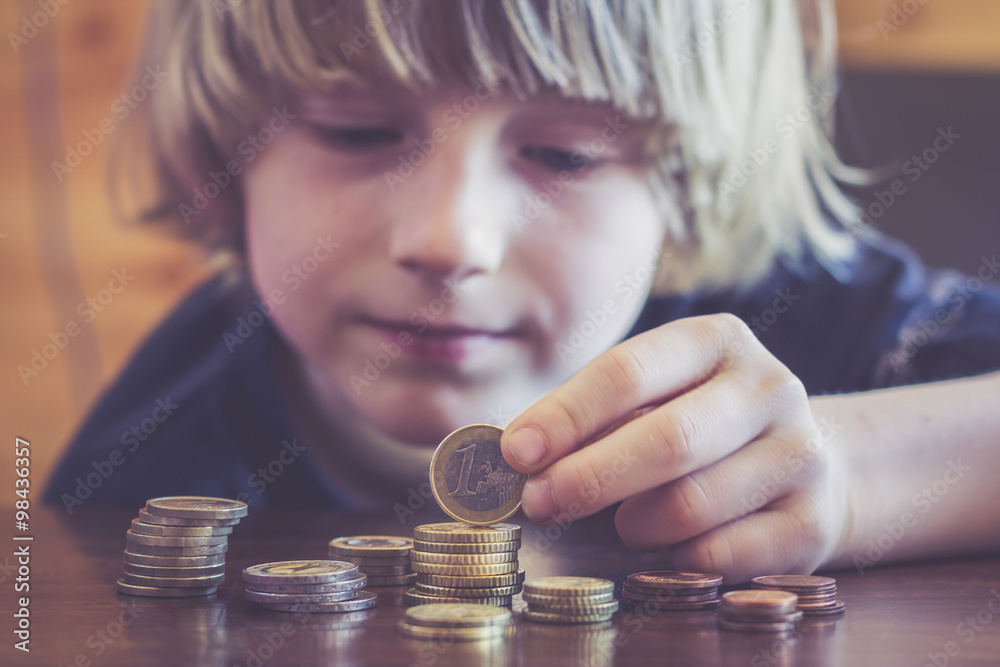 Little boy counting coins Stock Photo | Adobe Stock