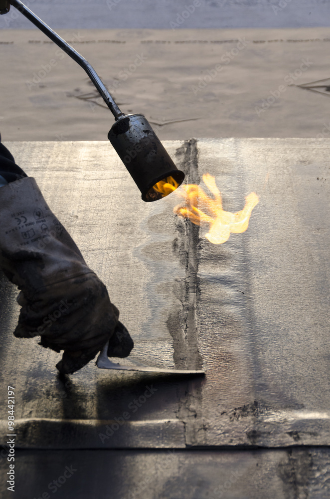 flame during welding of a waterproofing membrane on a roof Stock Photo ...