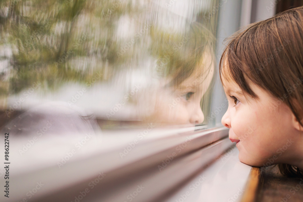Girl on a train looking out of the window Stock Photo | Adobe Stock