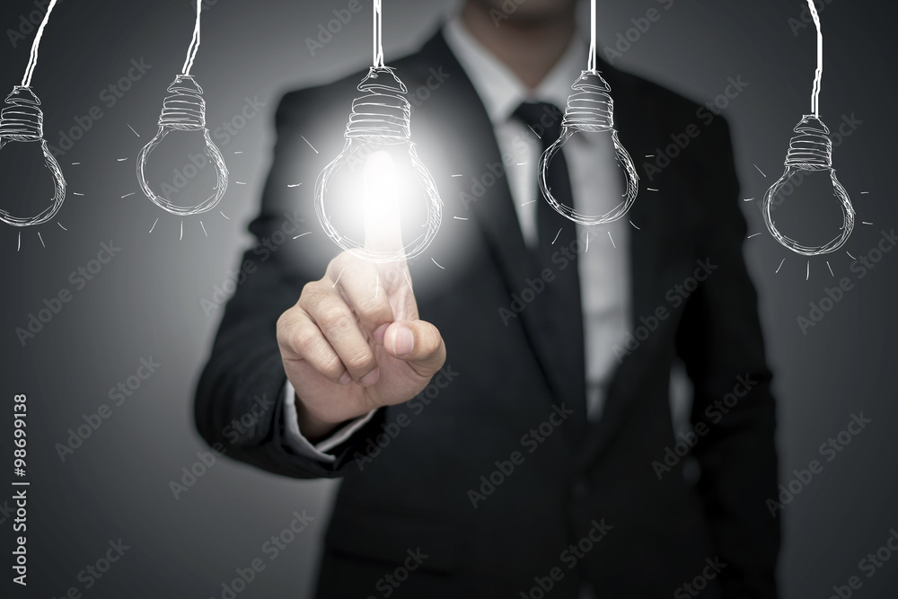 businessman pressing button with bulb Stock Photo | Adobe Stock
