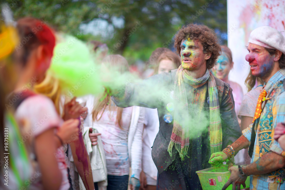 Clowns throwing Holi powder at passers; celebrating Spring Festival ...