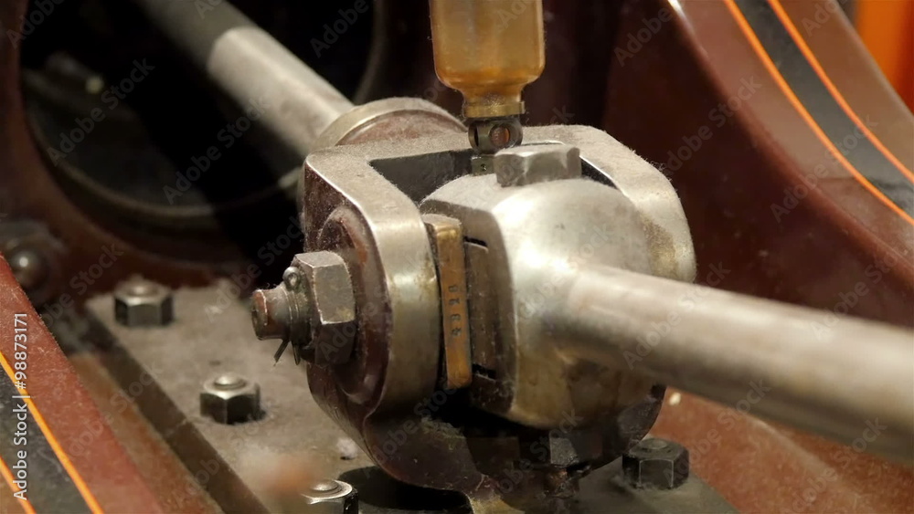 A pull up lever on the machinery of a car. The rust on the machine and ...