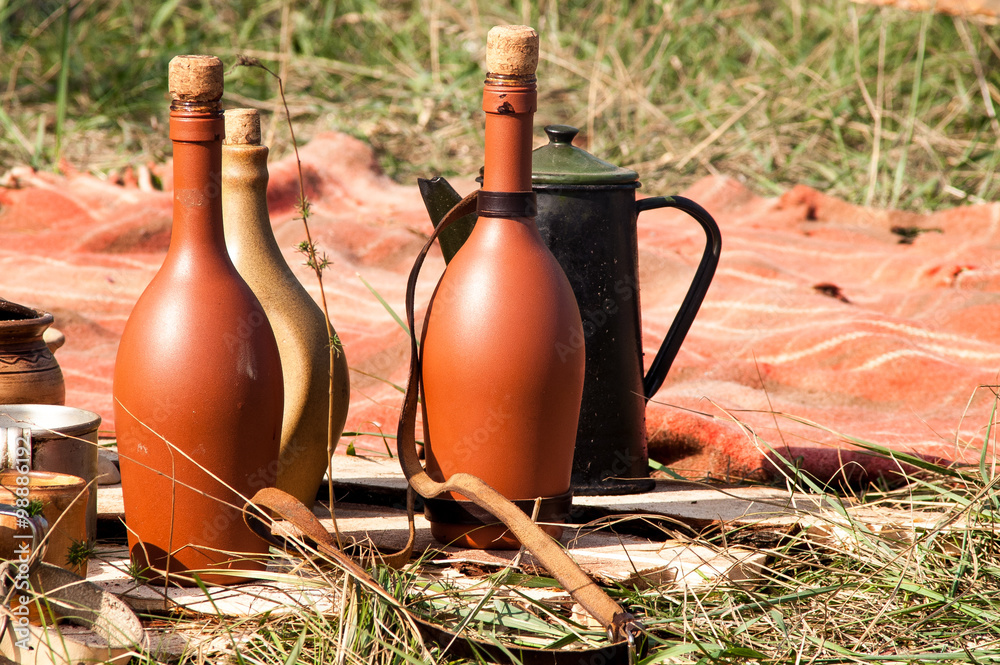 Mug, clay bottle on table laying on the ground in the medieval p Stock ...