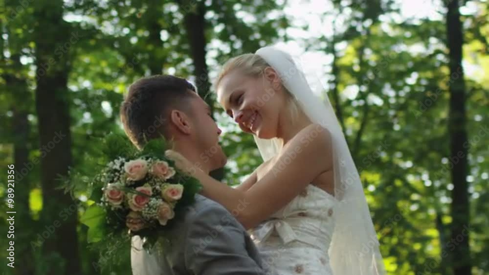 Just married couple hug each other in a sunny park Stock ビデオ | Adobe Stock
