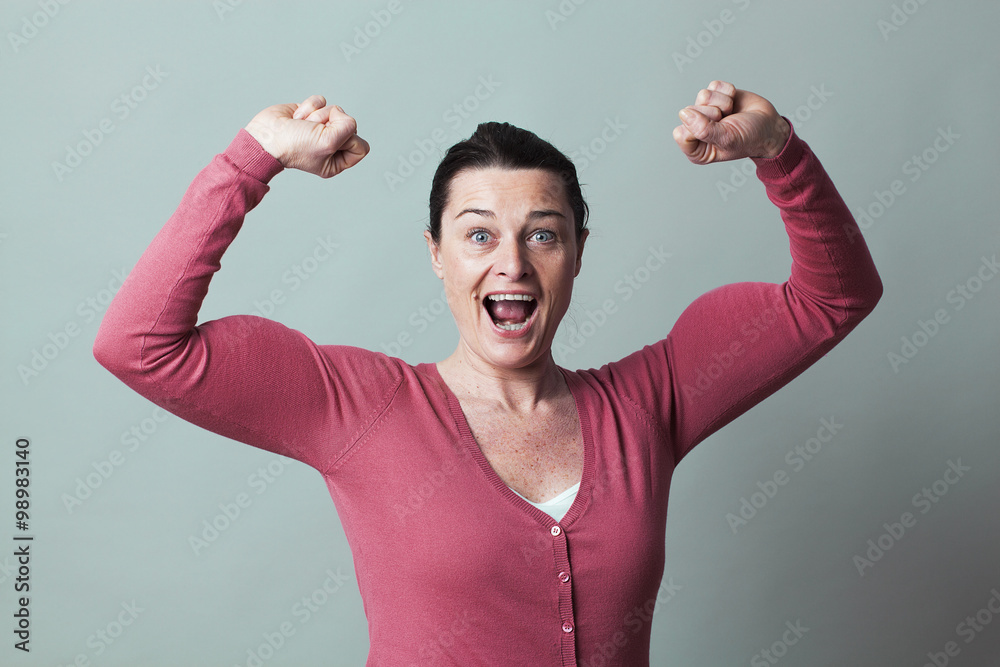 muscle concept - laughing beautiful 40s woman proud of flexing her big ...