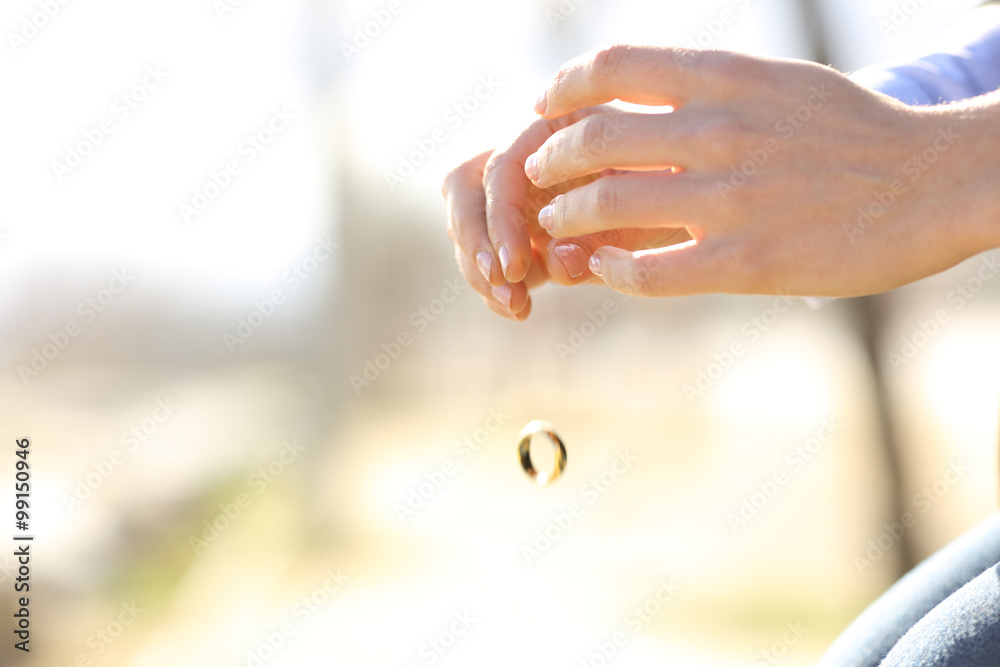 Sad wife hands dropping her wedding ring Stock Photo | Adobe Stock