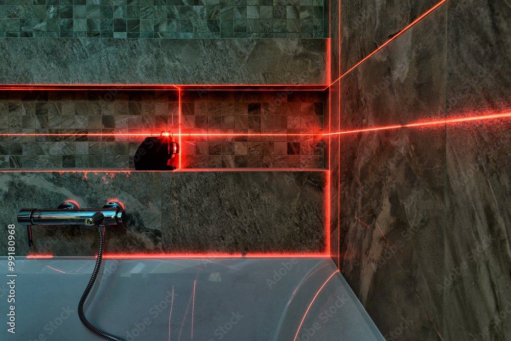 Red laser light lines for level measure during bathroom renovation ...