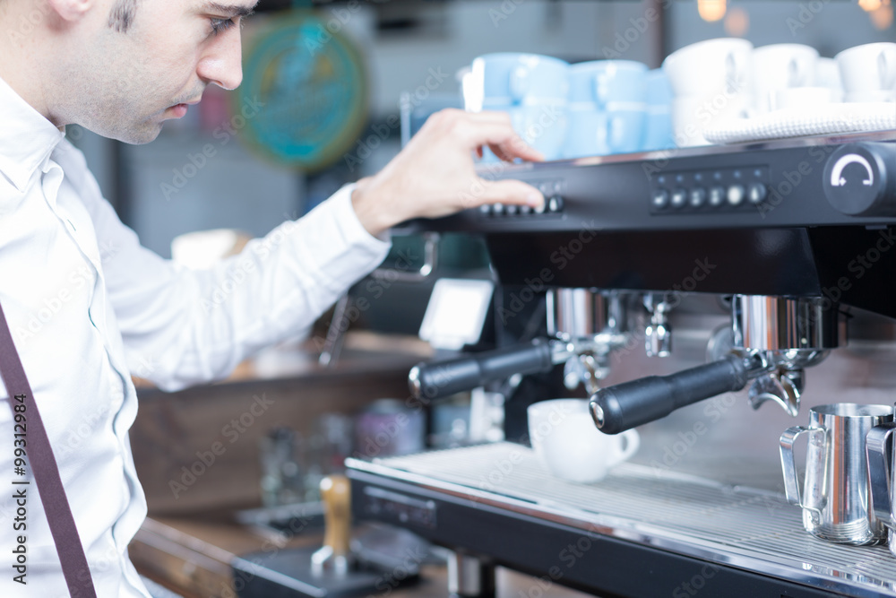 Side view of bartender pushing the button on coffee machine Stock Photo ...
