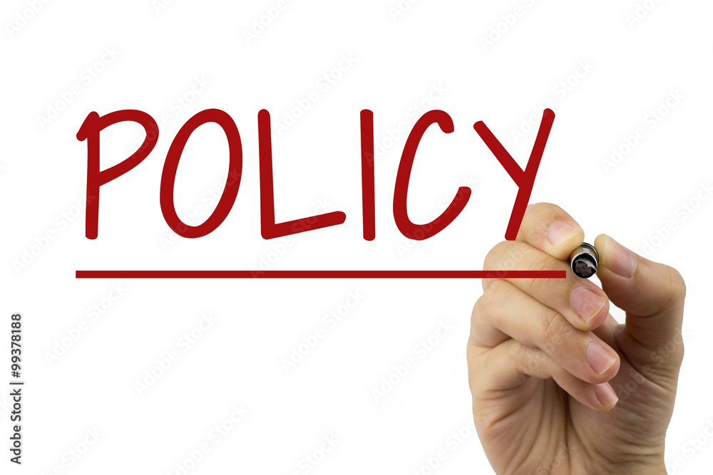 Policy - Female hand with pen writing text on white background Stock ...