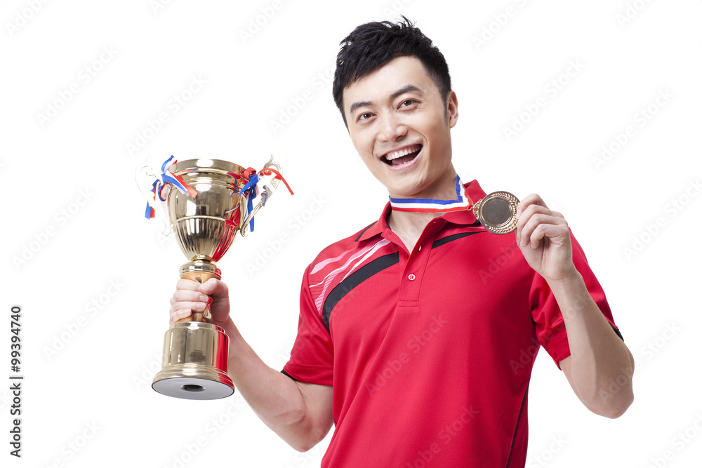 Male athlete celebrating victory with gold medal and trophy Stock Photo ...
