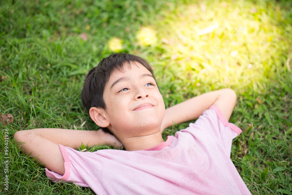 Little boy laying down on the grass dreaming light Stock Photo | Adobe ...