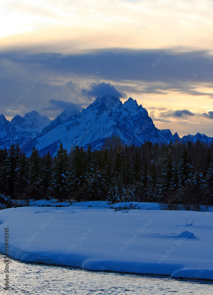Snake River at twilight below the Grand Teton mountain range peaks in ...