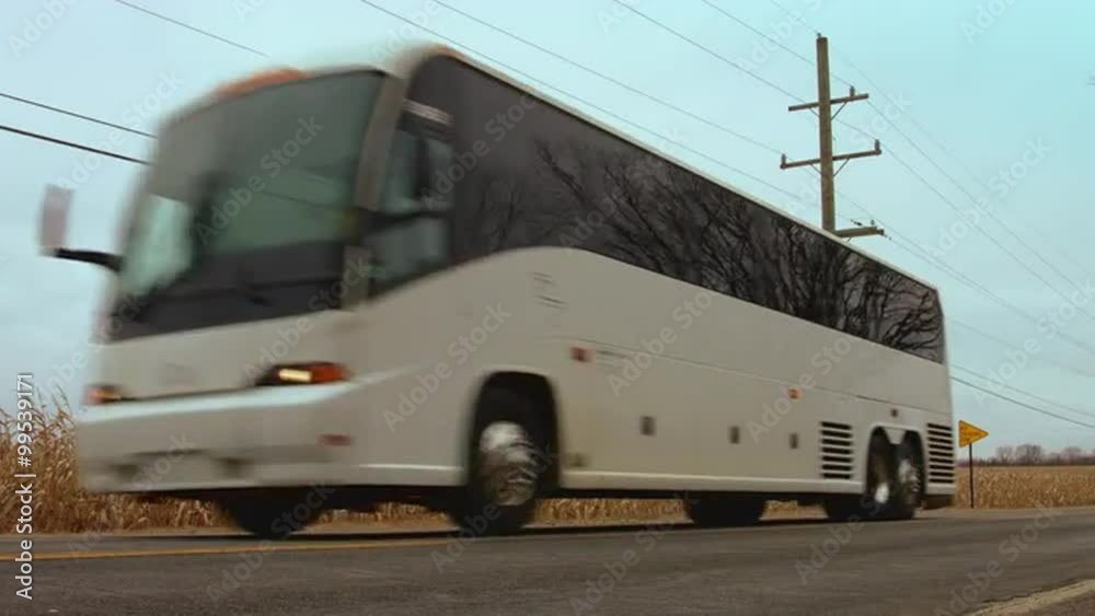 Vidéo Stock Coach (bus) passing a field of corn (maize). Low viewpoint ...