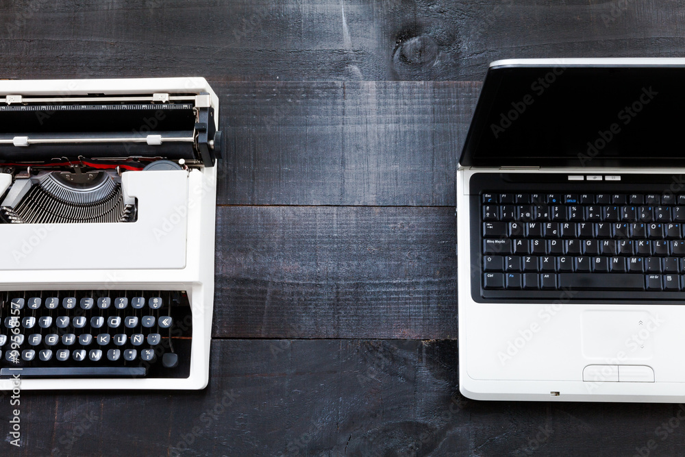 The image represents a retro typewriter and a laptop on a dark wood ...