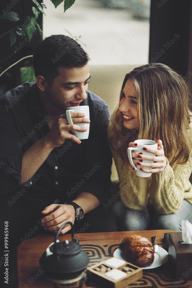 Couple in love drinking coffee in coffee shop Stock Photo | Adobe Stock