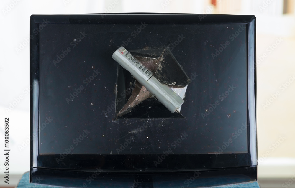 Remote control stuck inside broken computer screen Stock Photo | Adobe ...