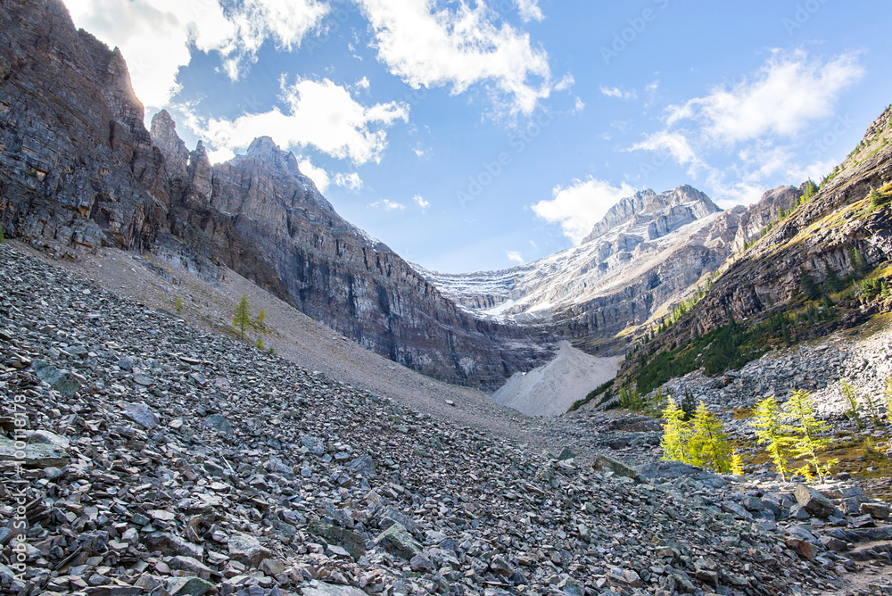 pile of rocks in front of the cliff of a peak in the national park of ...