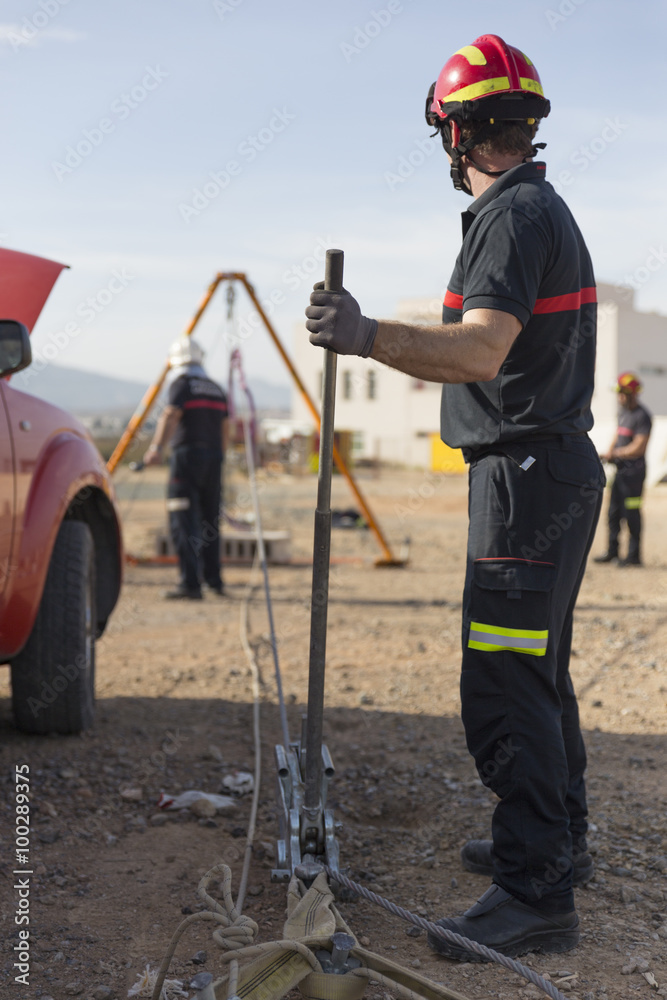 firefighter working with a mechanical tensioning steel cable Stock ...