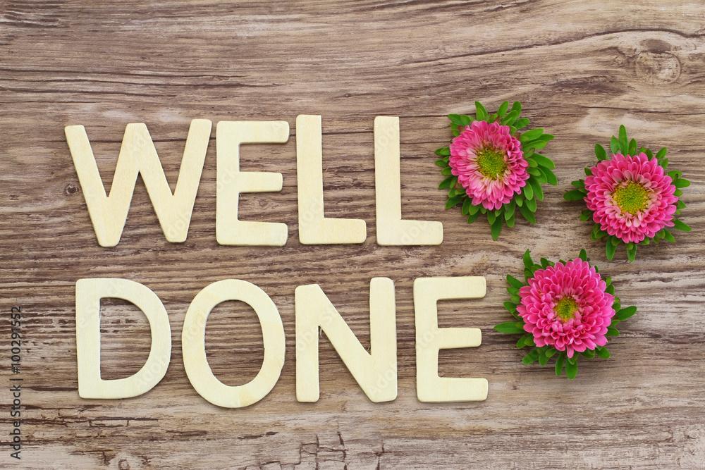 Well done written with wooden letters and pink daisy flowers Stock ...